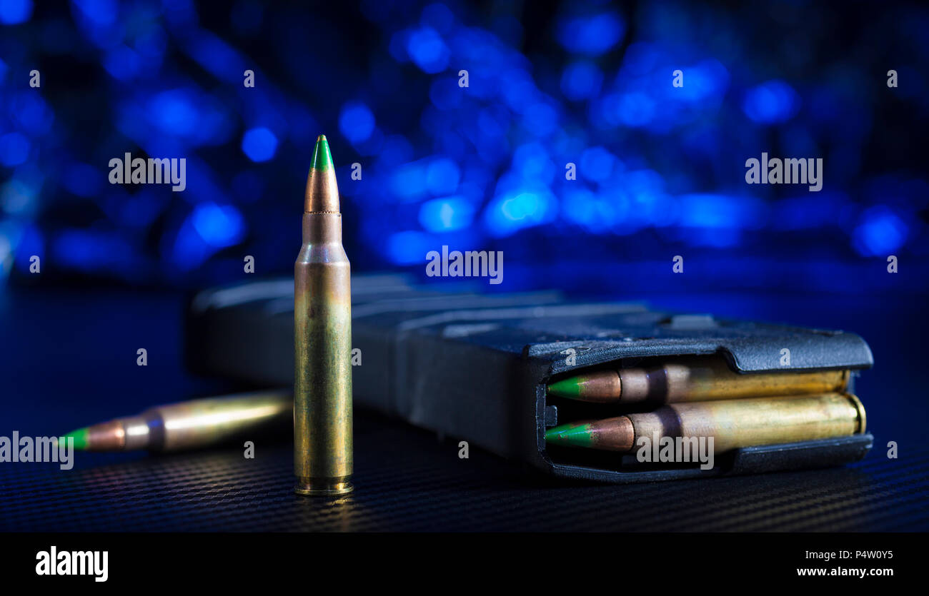 Magazine for an AR-15 loaded with ammo and cartridges with blue behind ...