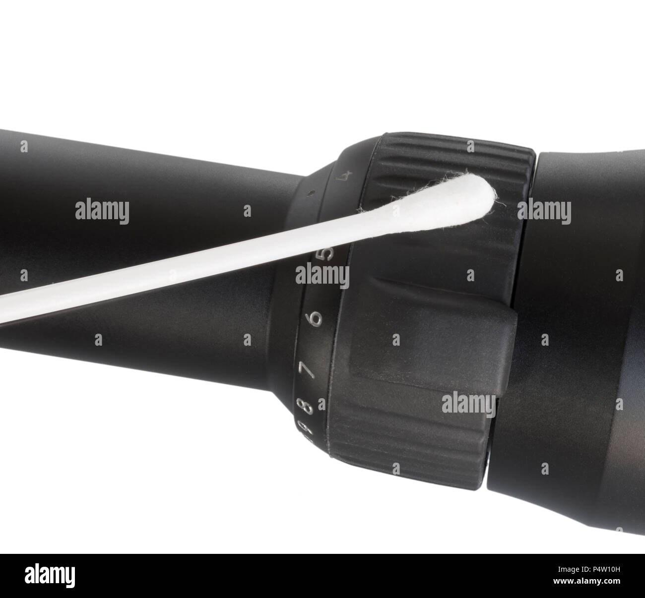 Cotton swab on the power dial cleaning a rifle scope isolated on white ...