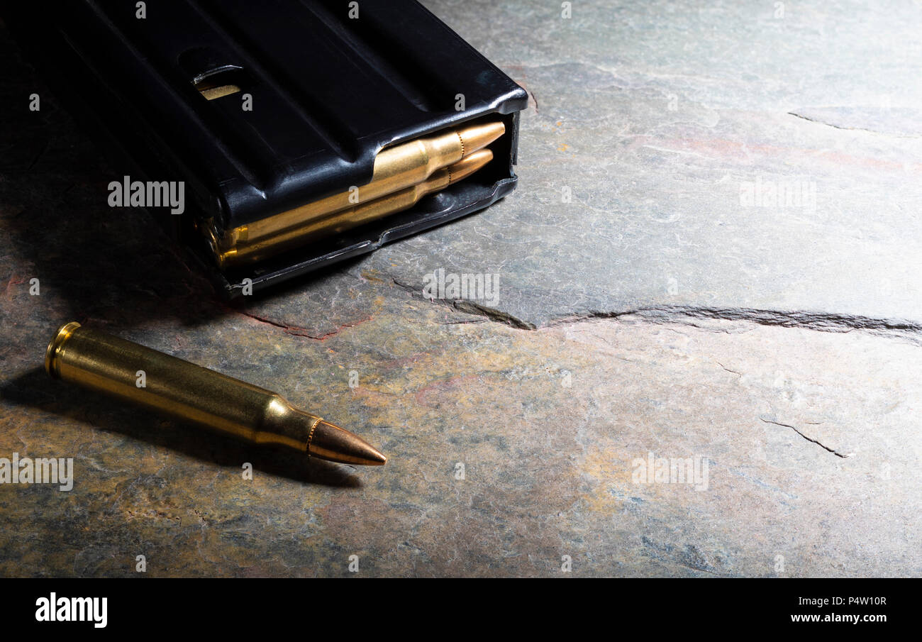 Magazine for an AR-15 loaded with a cartridge laying nearby Stock Photo ...