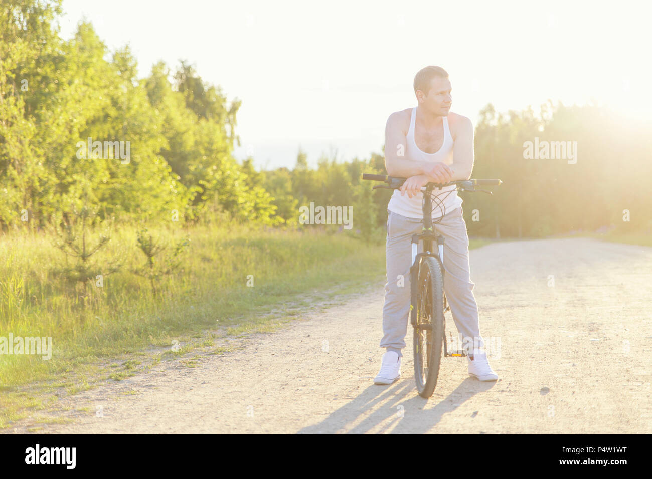 Man standing pose with cycle hi-res stock photography and images - Alamy