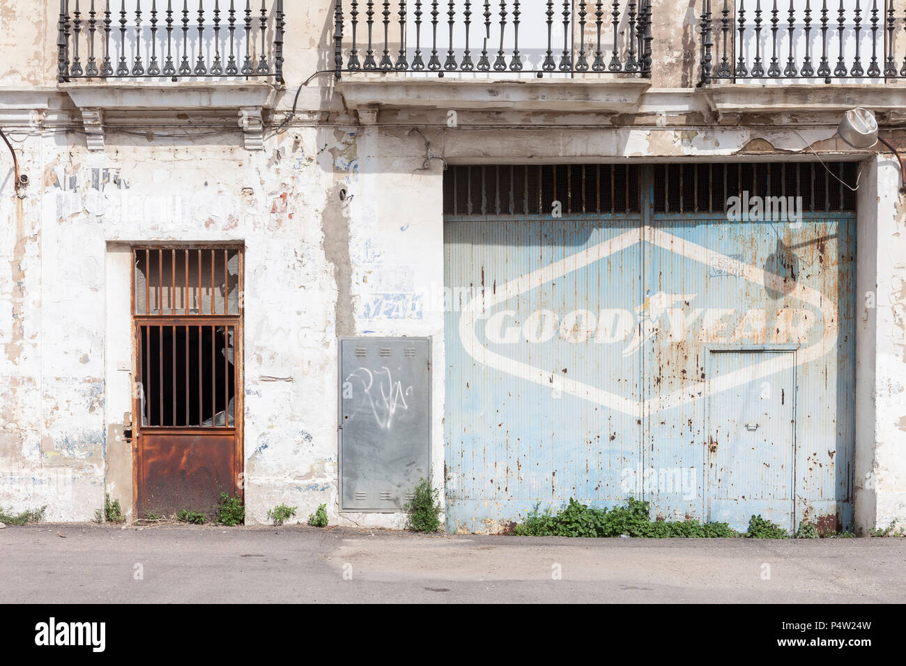 Valencia, Spain, gate to a derelict car repair shop in a commercial ...