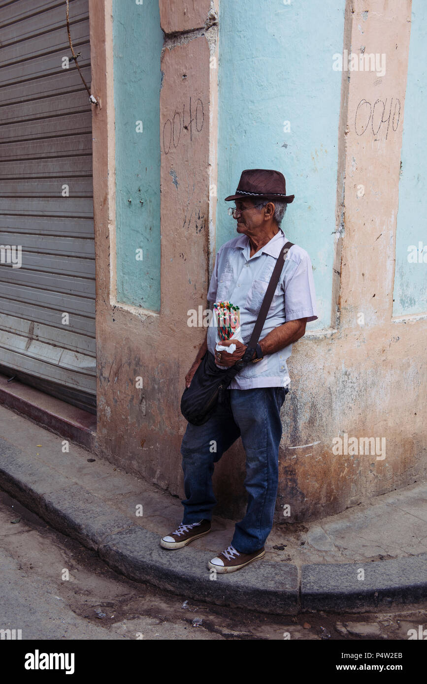 An elderly Cuban man is selling candy canes on the street corner in ...