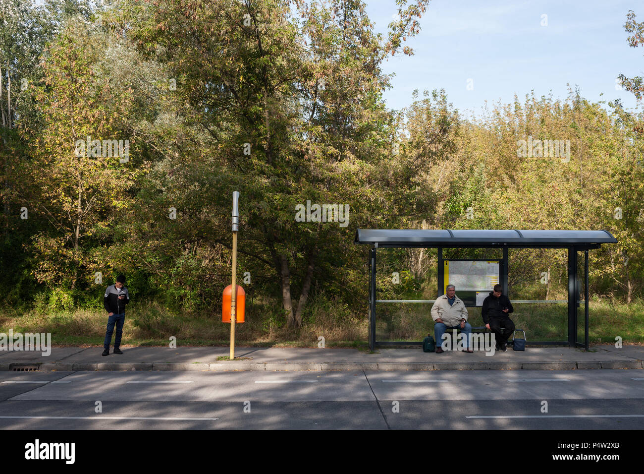 Berlin, Germany, passengers are waiting at a bus stop on the outskirts ...