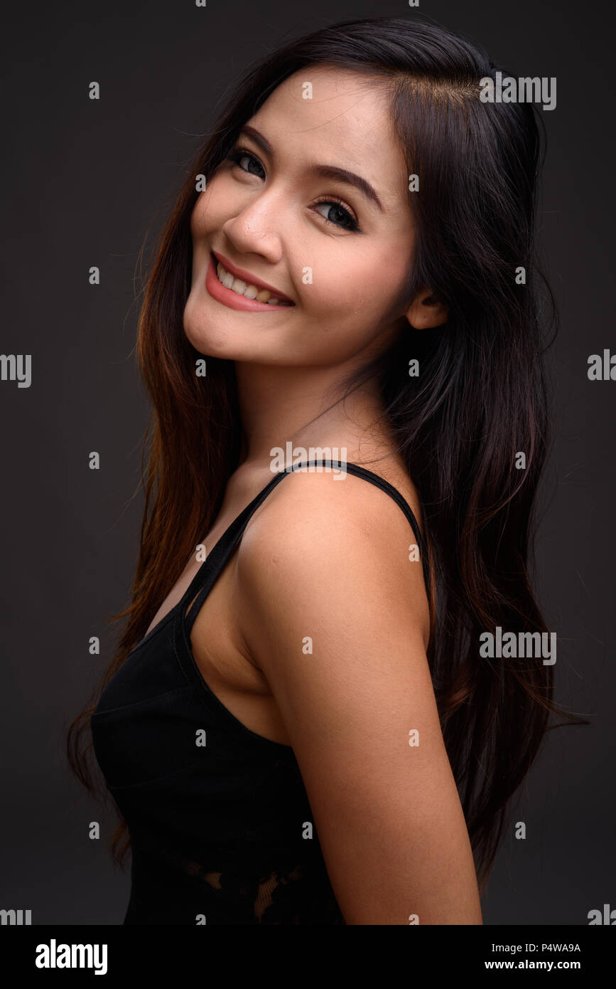 Young beautiful Asian woman smiling Stock Photo - Alamy