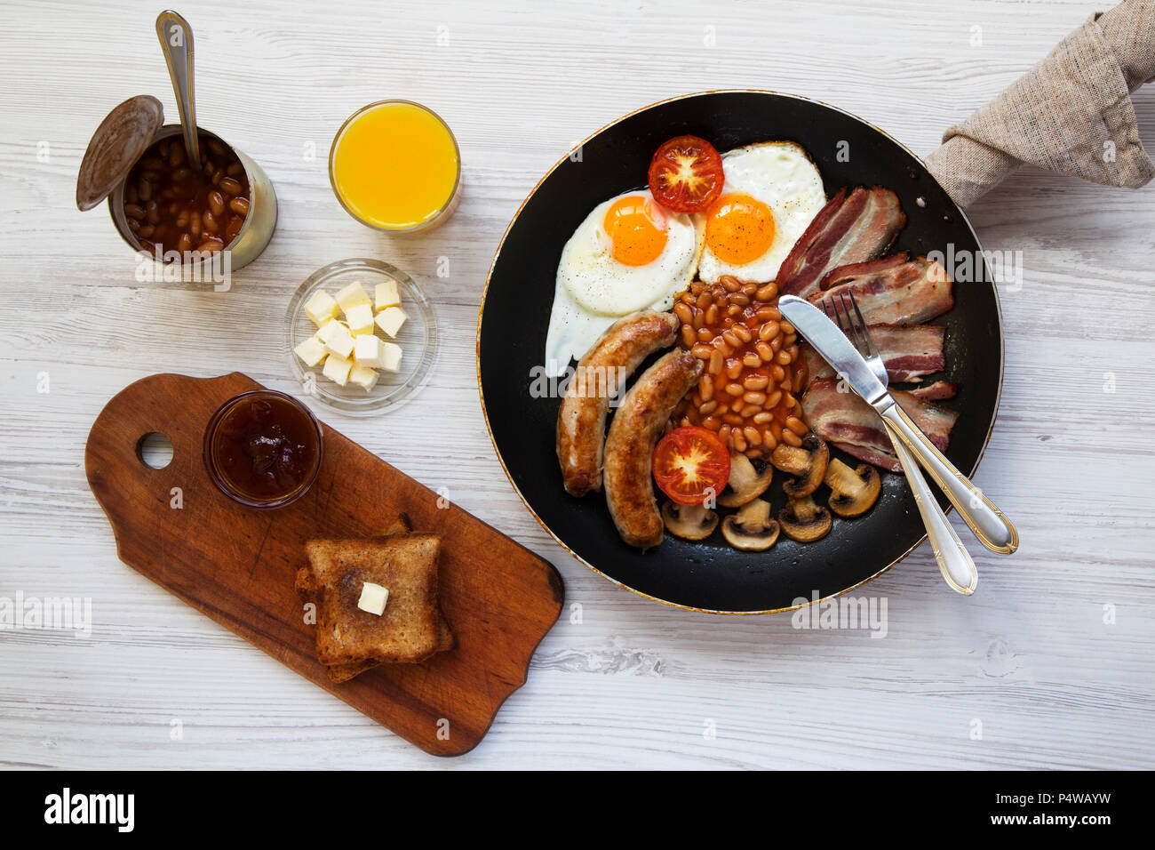 Full english breakfast in a frying pan with fried eggs, bacon, sausages ...