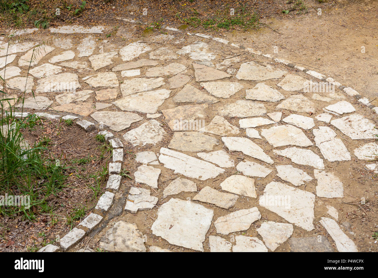 Block of stones forming a circular pathway. Patterned bricks lining the ...