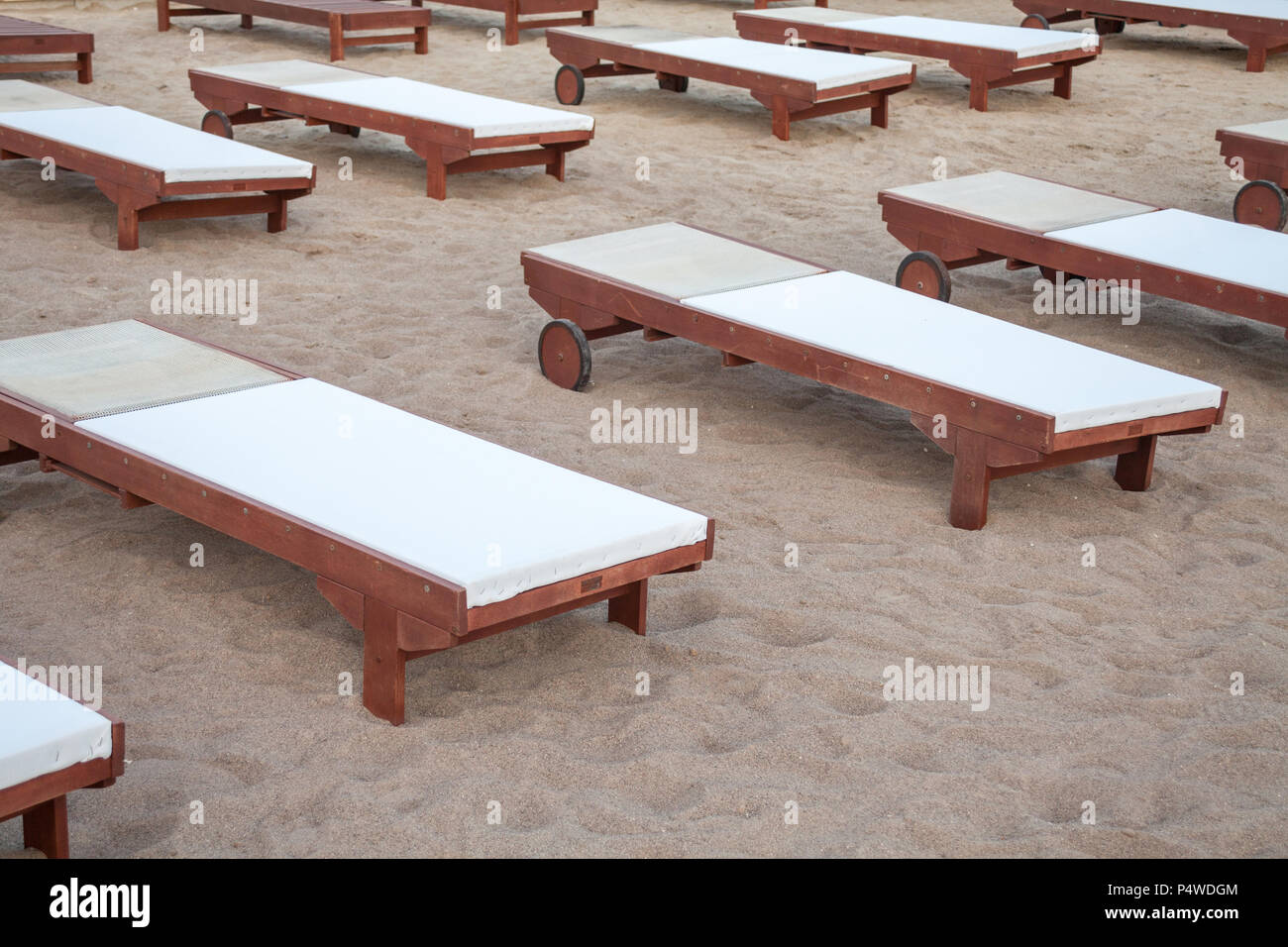 A relaxing beds fix in the sand. A flat structure filled with comfy ...