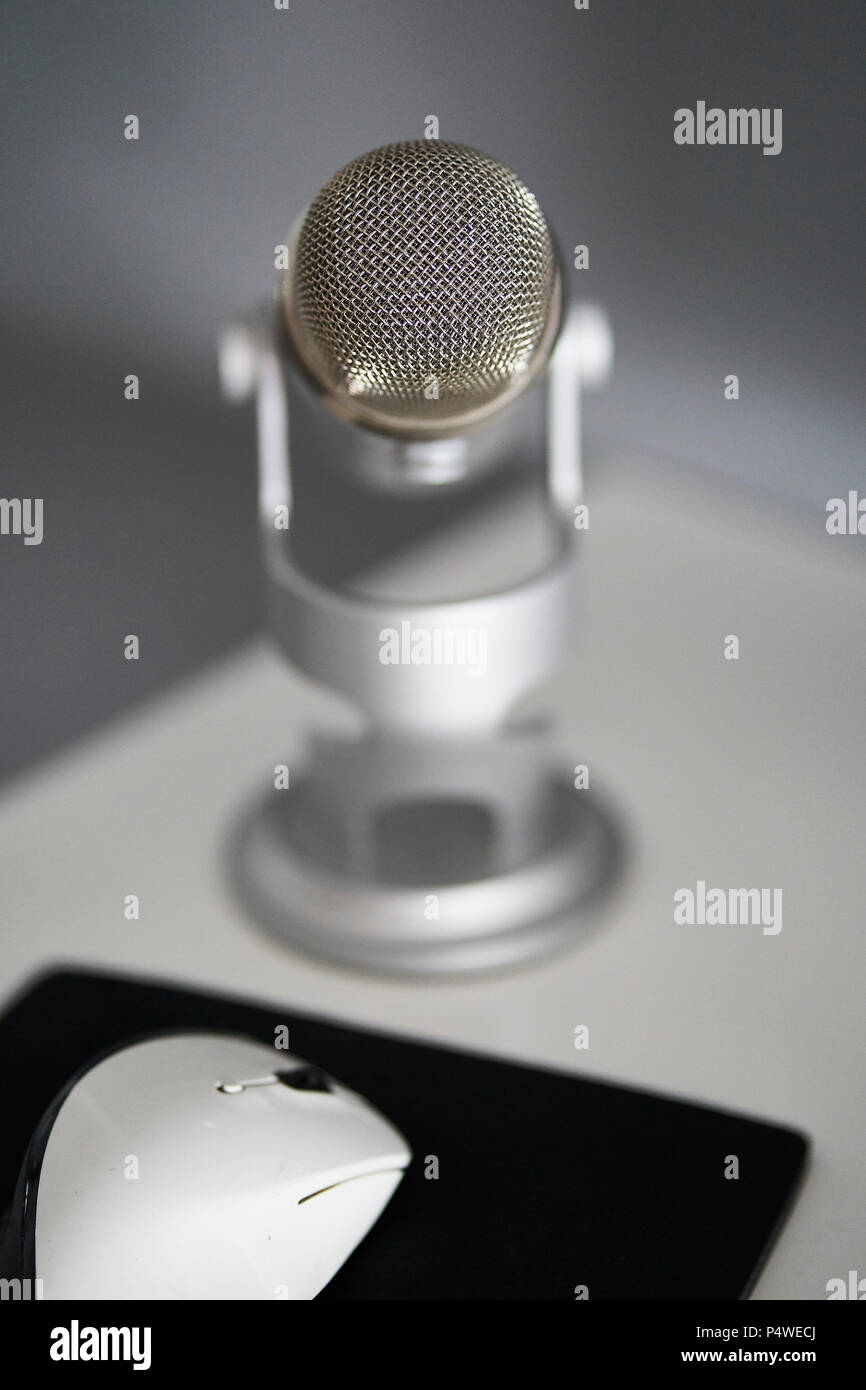Grey microphone in a white table Stock Photo - Alamy