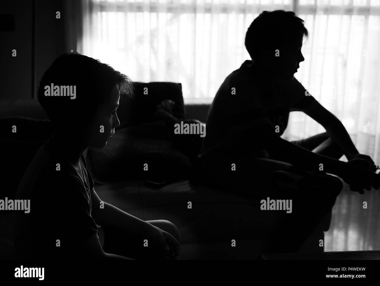 Boys playing console at home Stock Photo - Alamy