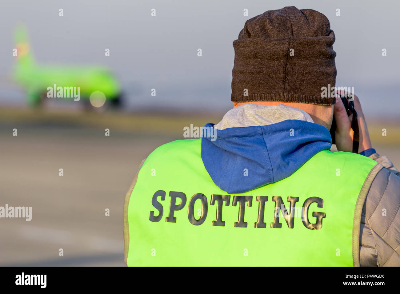 Photographer makes photo of plane on airfield. Plane spotting, hobby ...