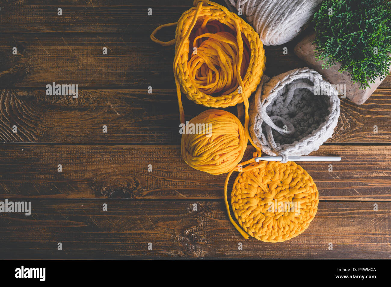Knitting. Home hobby. Wabi-Sabi-style composition on a wooden background. Top view. Easy vintage ...