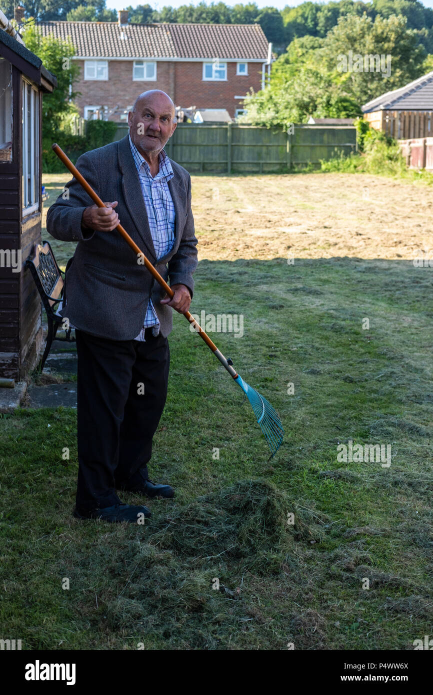 Male raking grass hi-res stock photography and images - Alamy