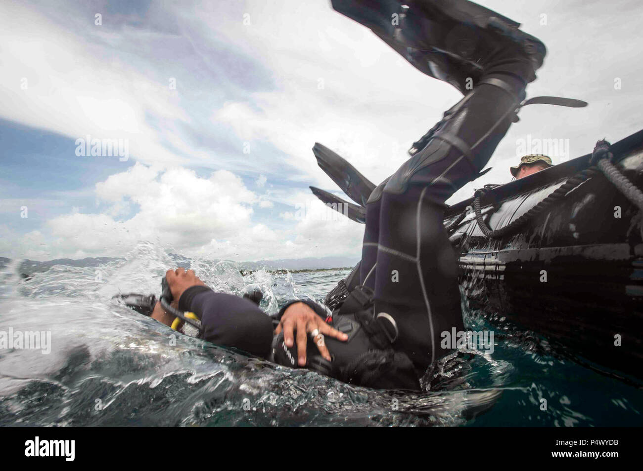 Philippine Sailors enter the water during an underwater construction ...