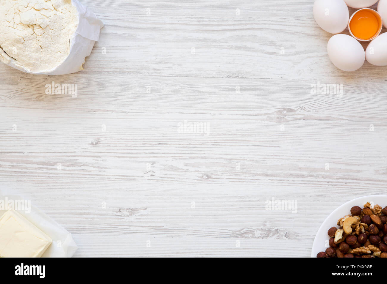Ingredients for making cookies on white wooden background. Top view ...