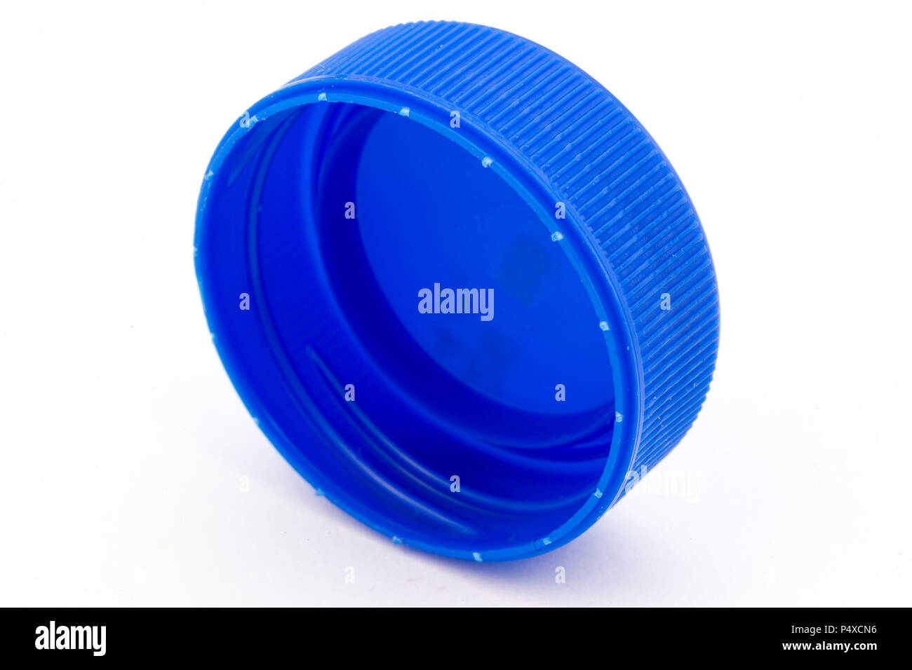 Blue plastic bottle cap. Studio shot. Plastic waste. Isolated on a ...