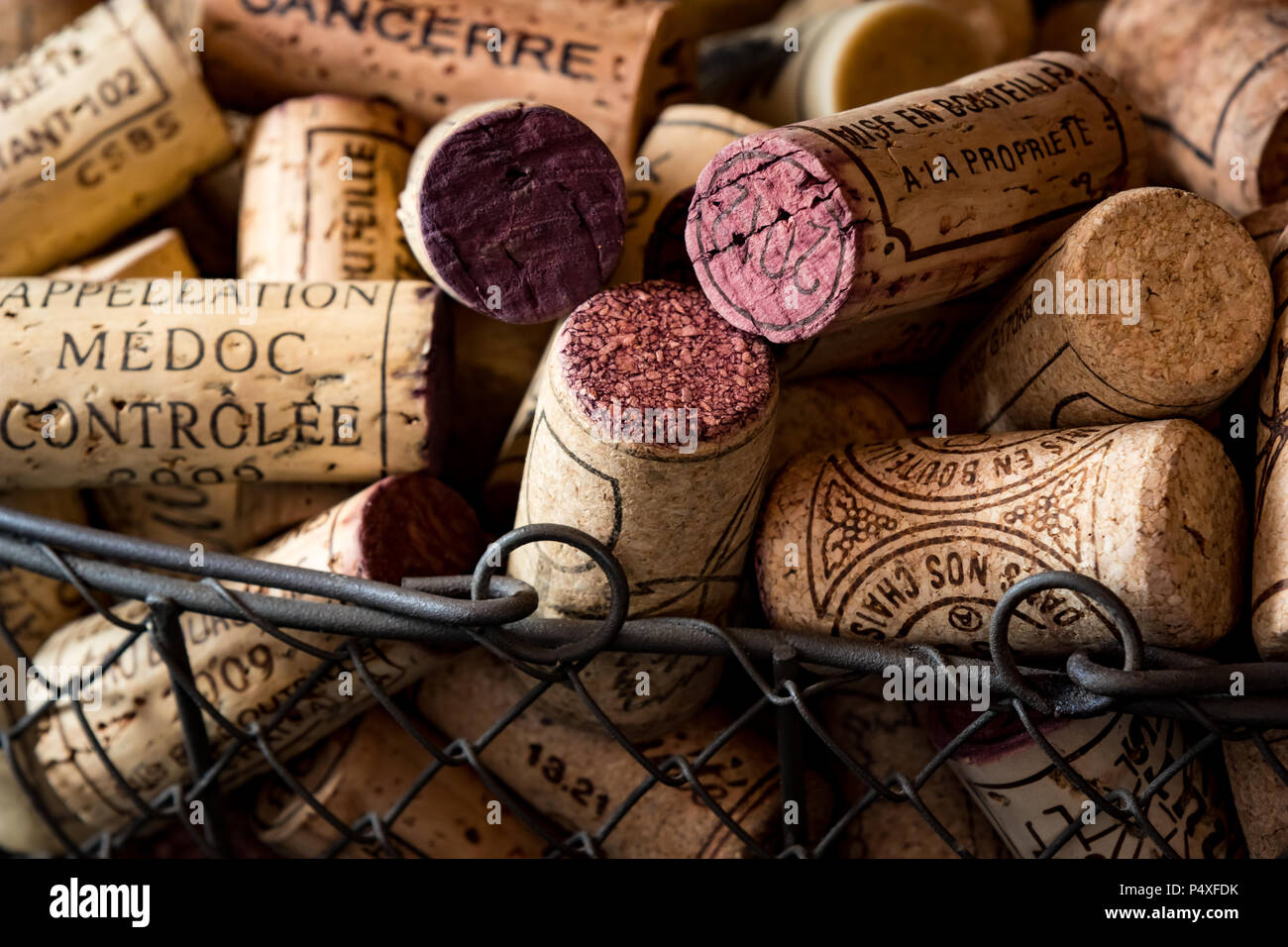 old cork stoppers of French wines in a wire basket Stock Photo - Alamy