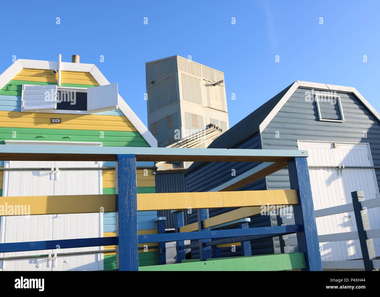 Beach huts & Factory Whitstable Kent Stock Photo - Alamy