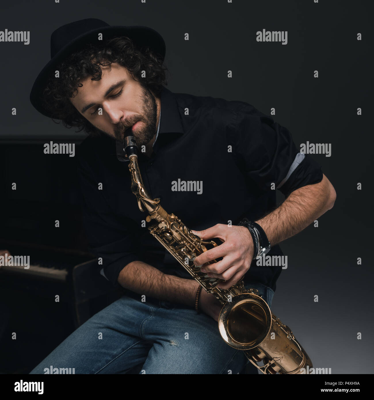 handsome young musician playing saxophone Stock Photo - Alamy