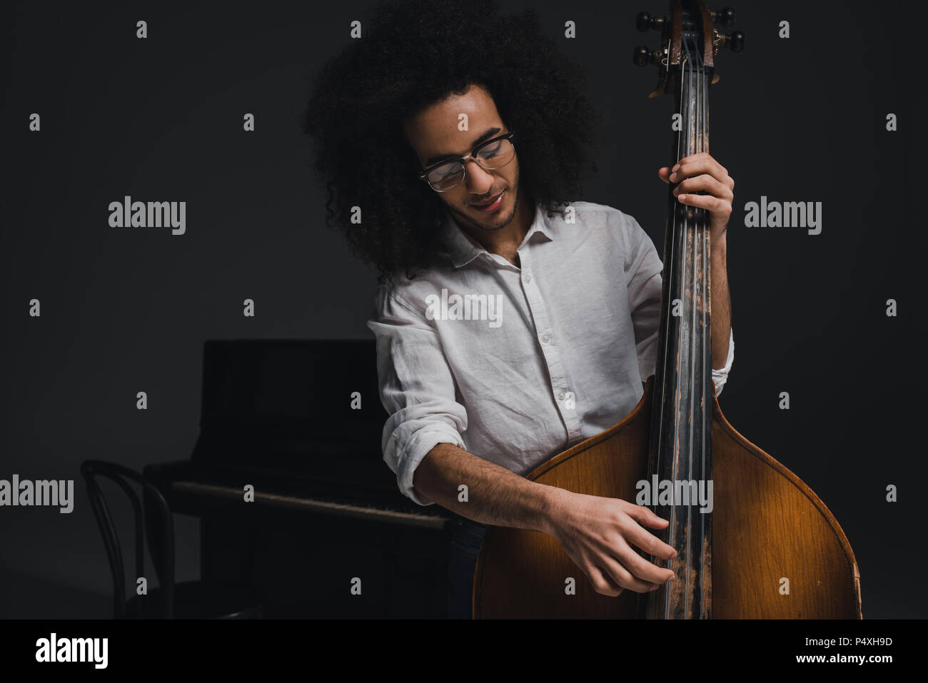 happy young musician playing standup bass Stock Photo - Alamy