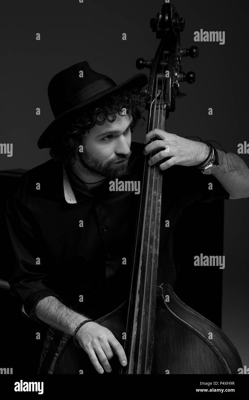 black and white shot of handsome musician playing standup bass Stock ...