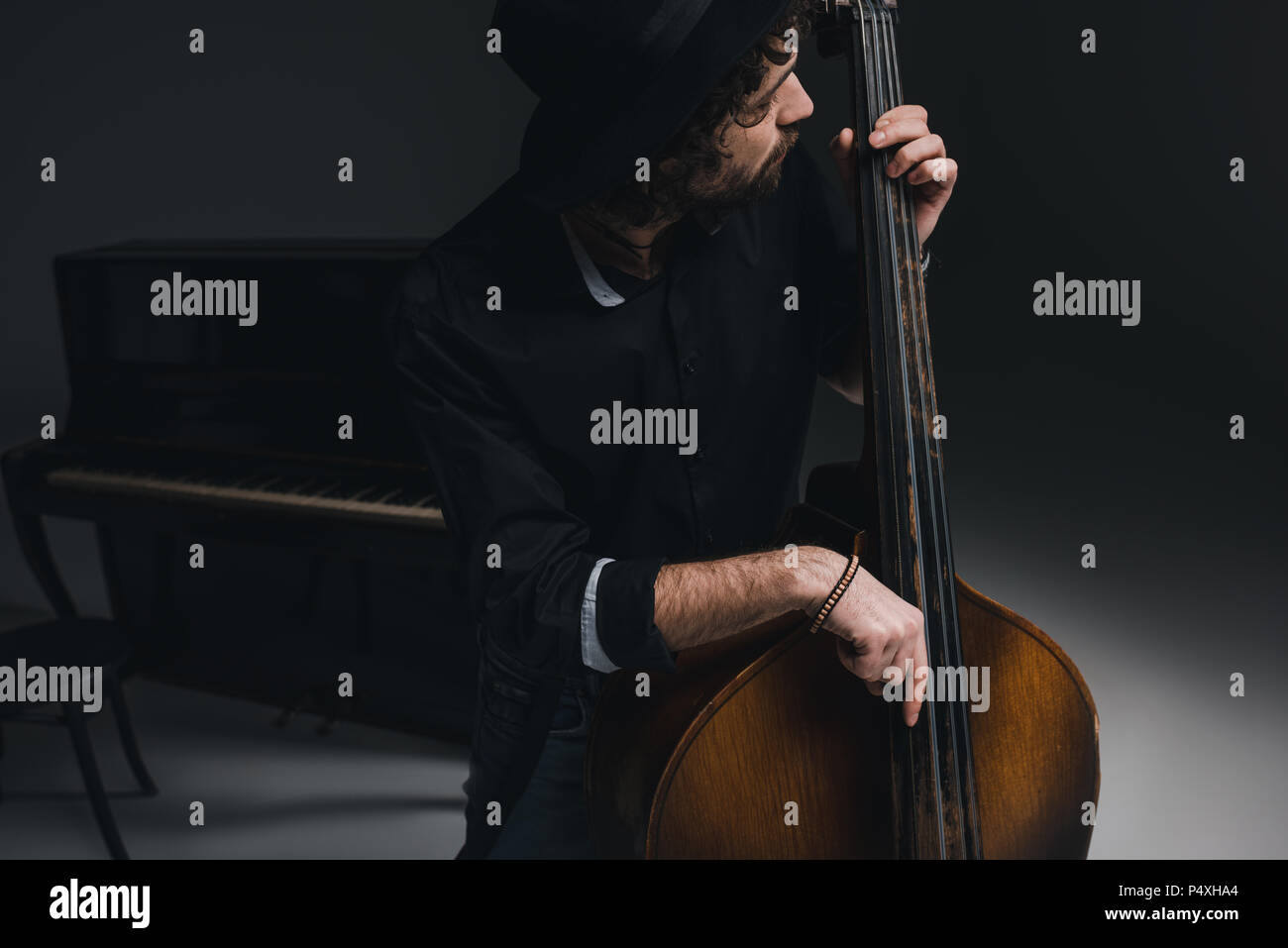 young handsome musician playing contrabass Stock Photo - Alamy