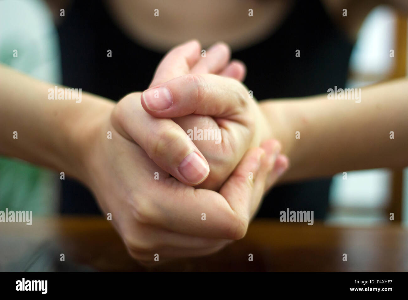 Woman cracking their knuckles Stock Photo - Alamy