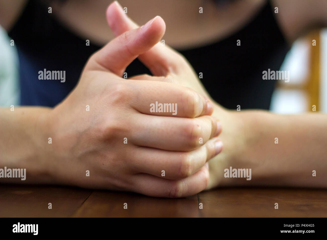 Woman cracking their knuckles Stock Photo - Alamy