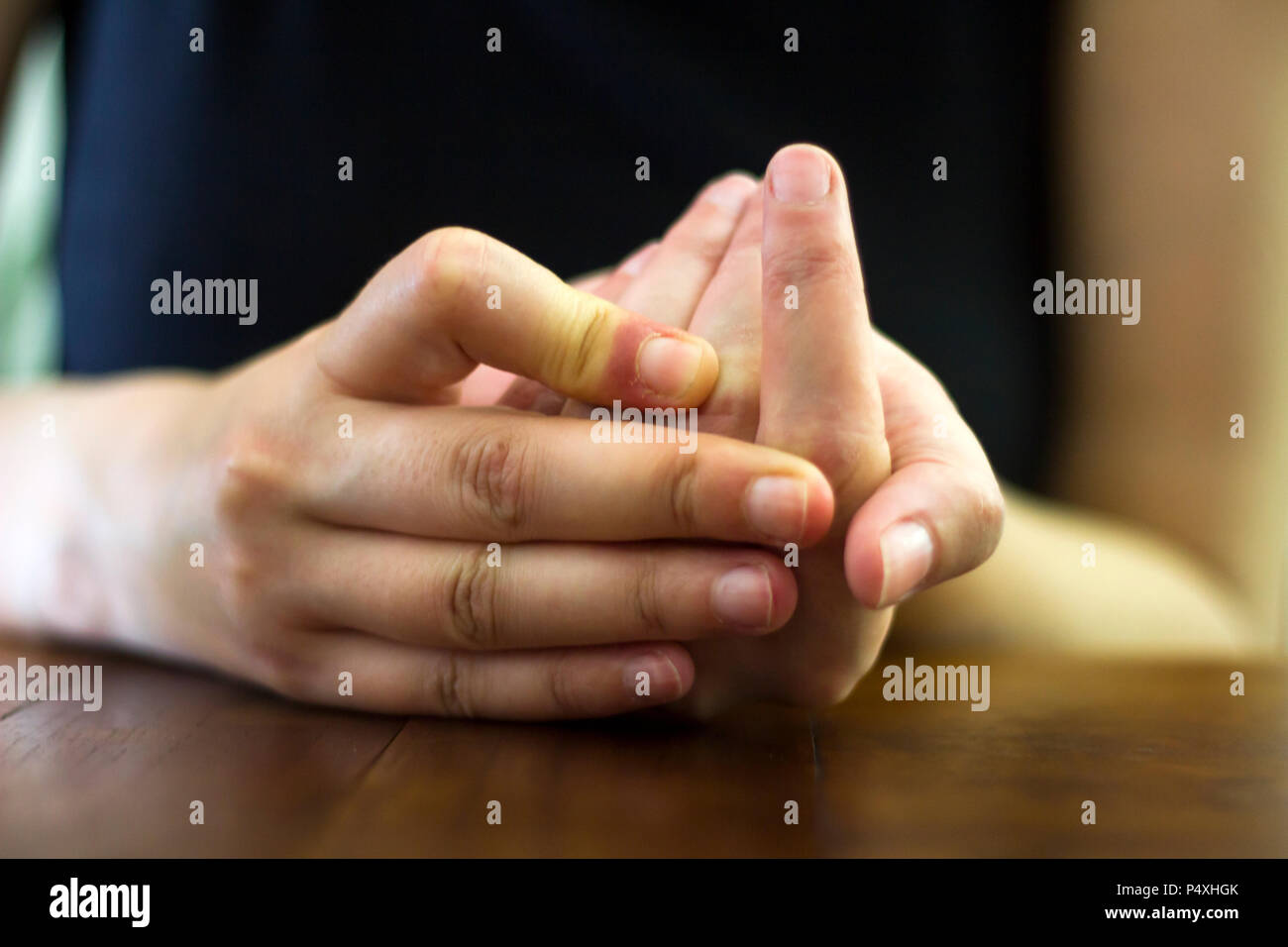 Woman cracking their knuckles Stock Photo - Alamy