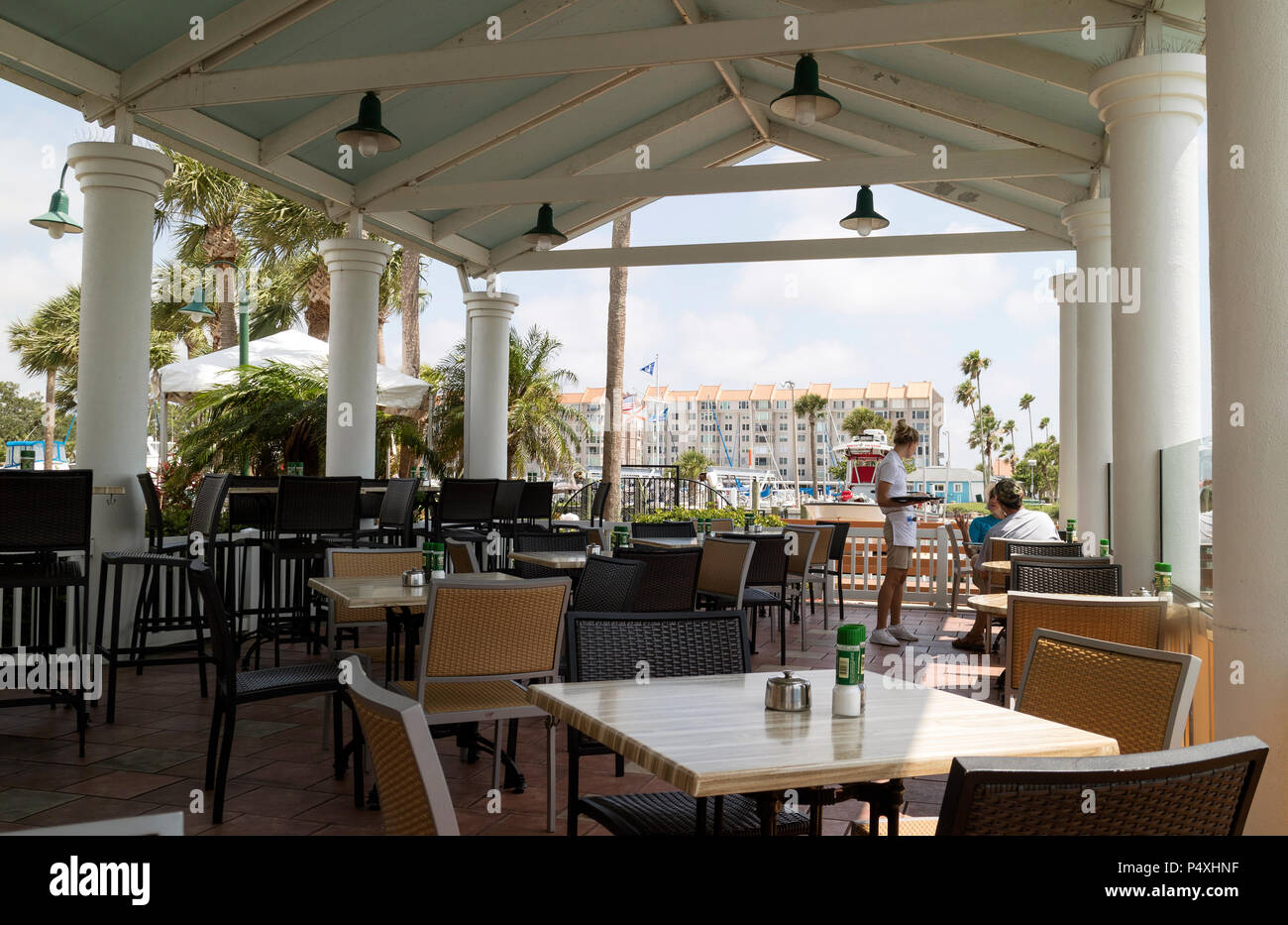 Dunedin, Florida, USA. Waitress talking to customers in a seafront ...