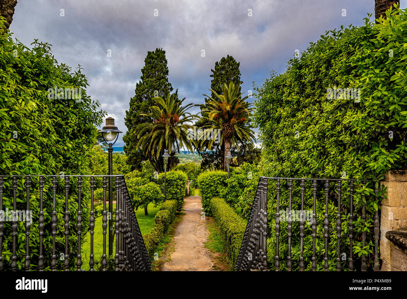 Italy Sardinia Sassari Monserrato Park entrance, bordered by cypresses ...