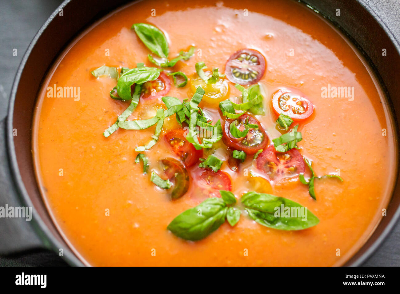 Roasted tomato soup in cast iron cooking pot Stock Photo - Alamy