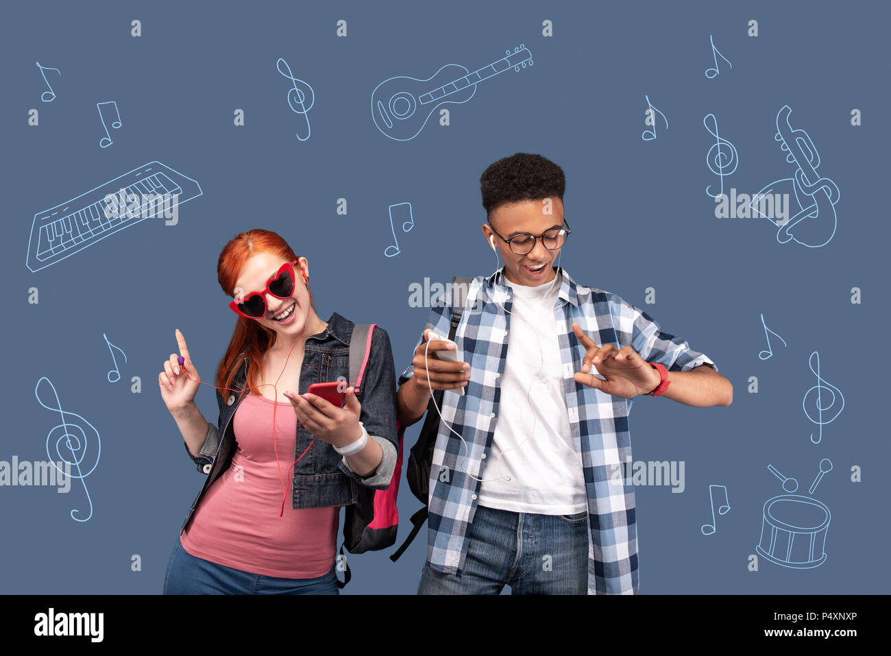 Energetic students wearing earphones and dancing with the music Stock ...