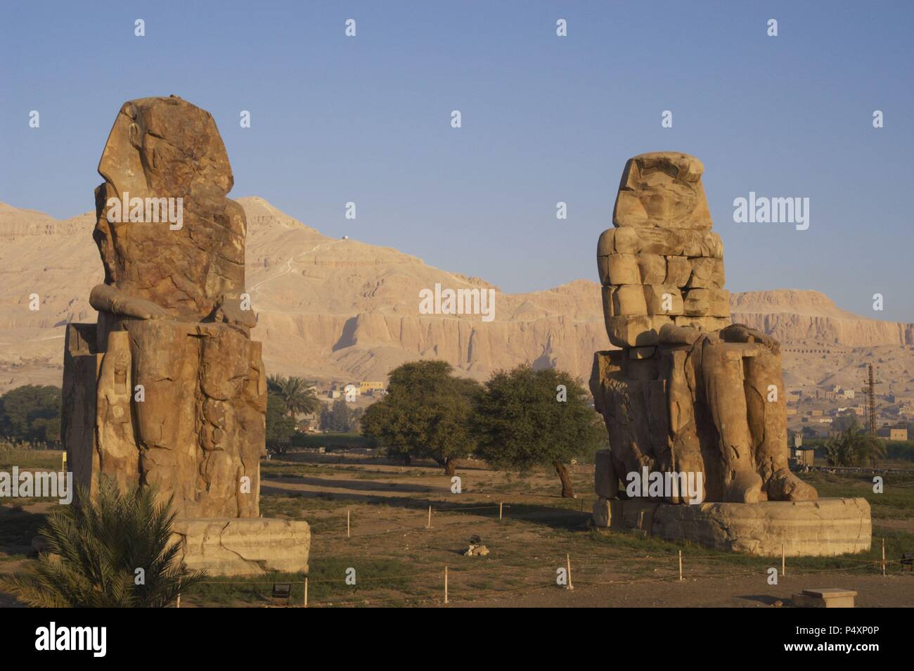 Colossi of Memnon. Stone statues depicting pharaoh Amenhotep III (14th ...
