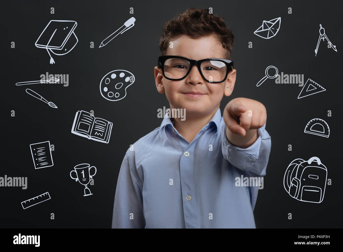 Cheerful boy pointing at young and smiling happily Stock Photo - Alamy