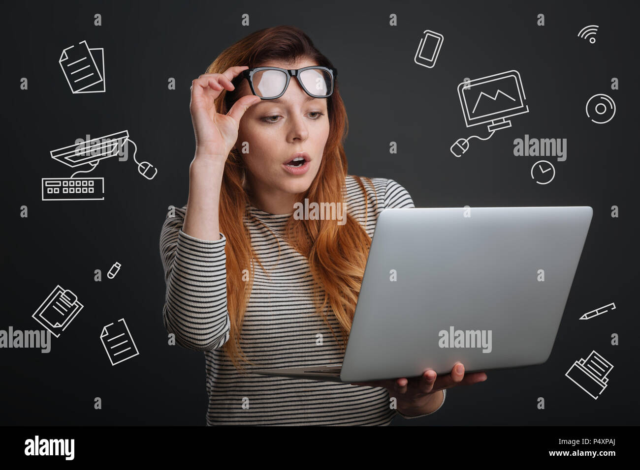 Surprised secretary putting her glasses up and looking at the screen ...