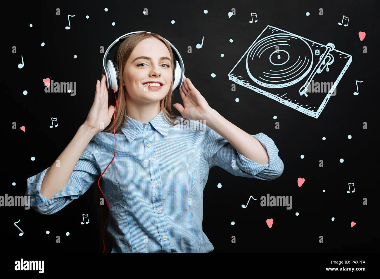 Young DJ smiling and enjoying the sound in her headphones Stock Photo ...