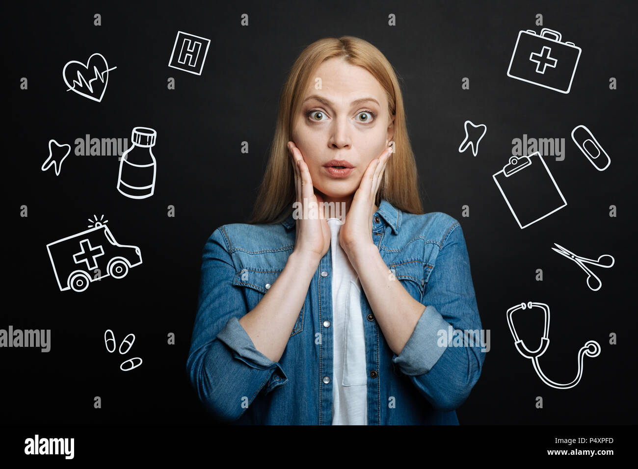 Emotional woman touching her face and looking surprised Stock Photo - Alamy