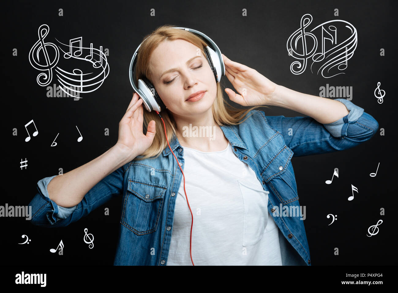 Calm woman relaxing while listening to music with her eyes closed Stock ...