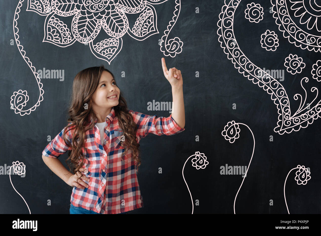 Cute child pointing to a flower and smiling Stock Photo - Alamy