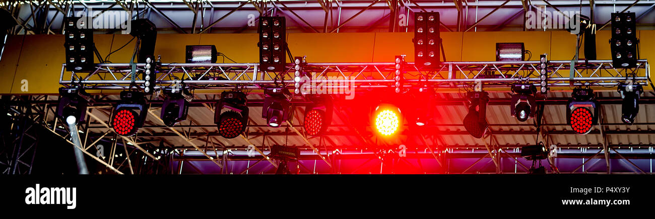 Red stage spotlights and illumination equipment on stage background or ...
