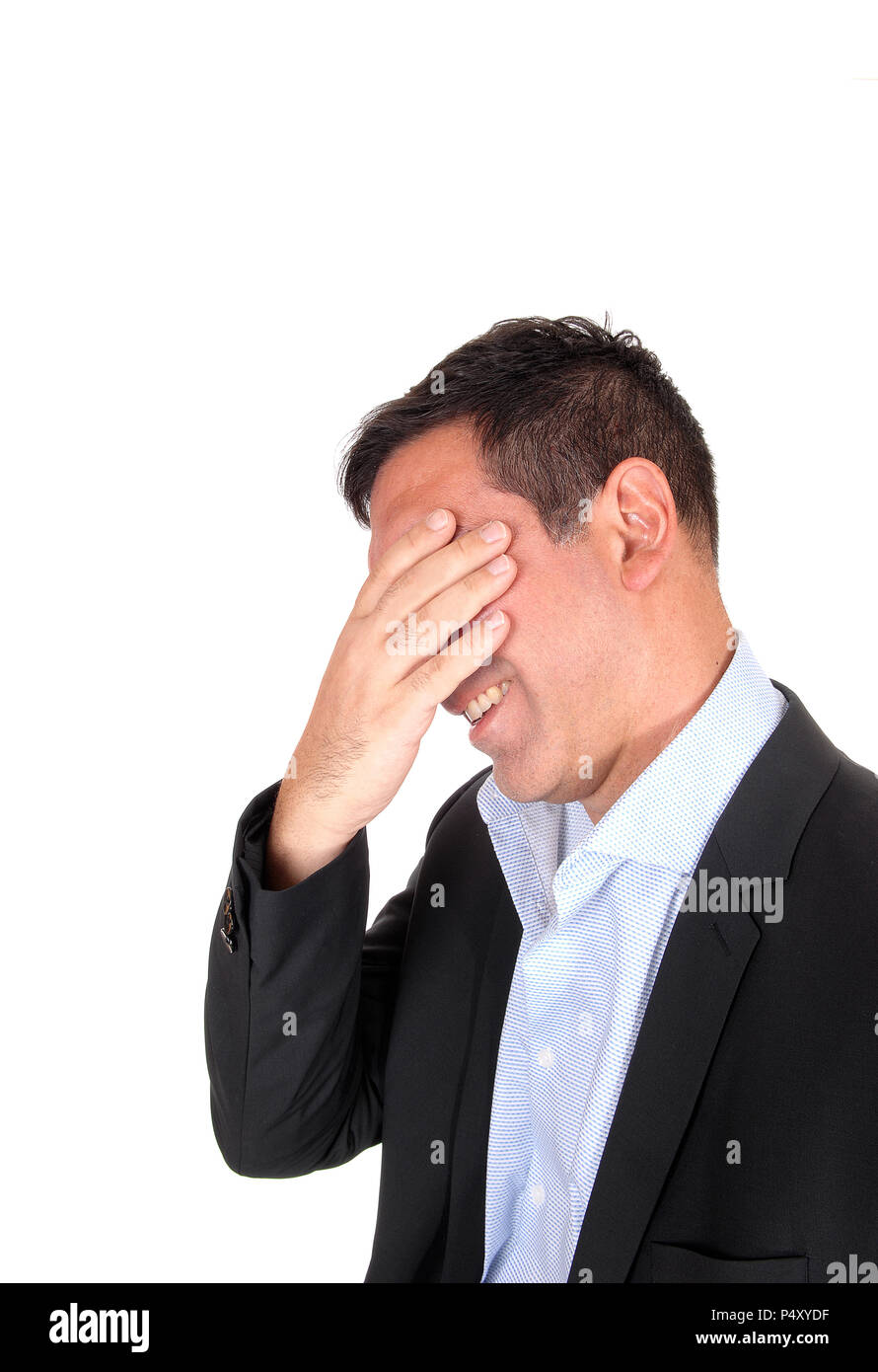 A close up image om a businessman in profile in a suit covering his ...