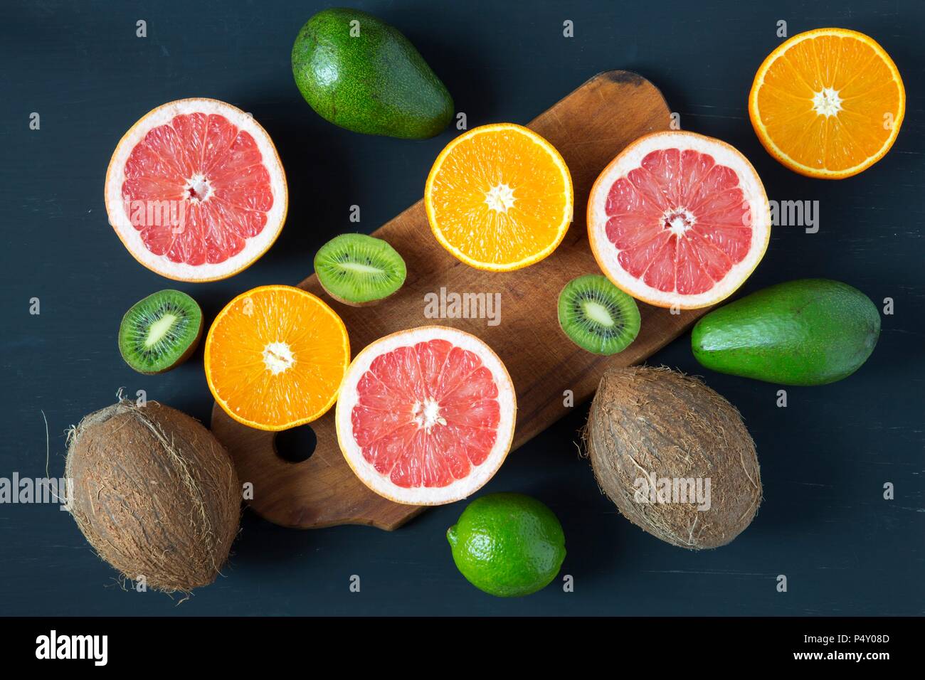 Flat lay. Top view. Sliced colorful fresh fruits: kiwi, orange ...