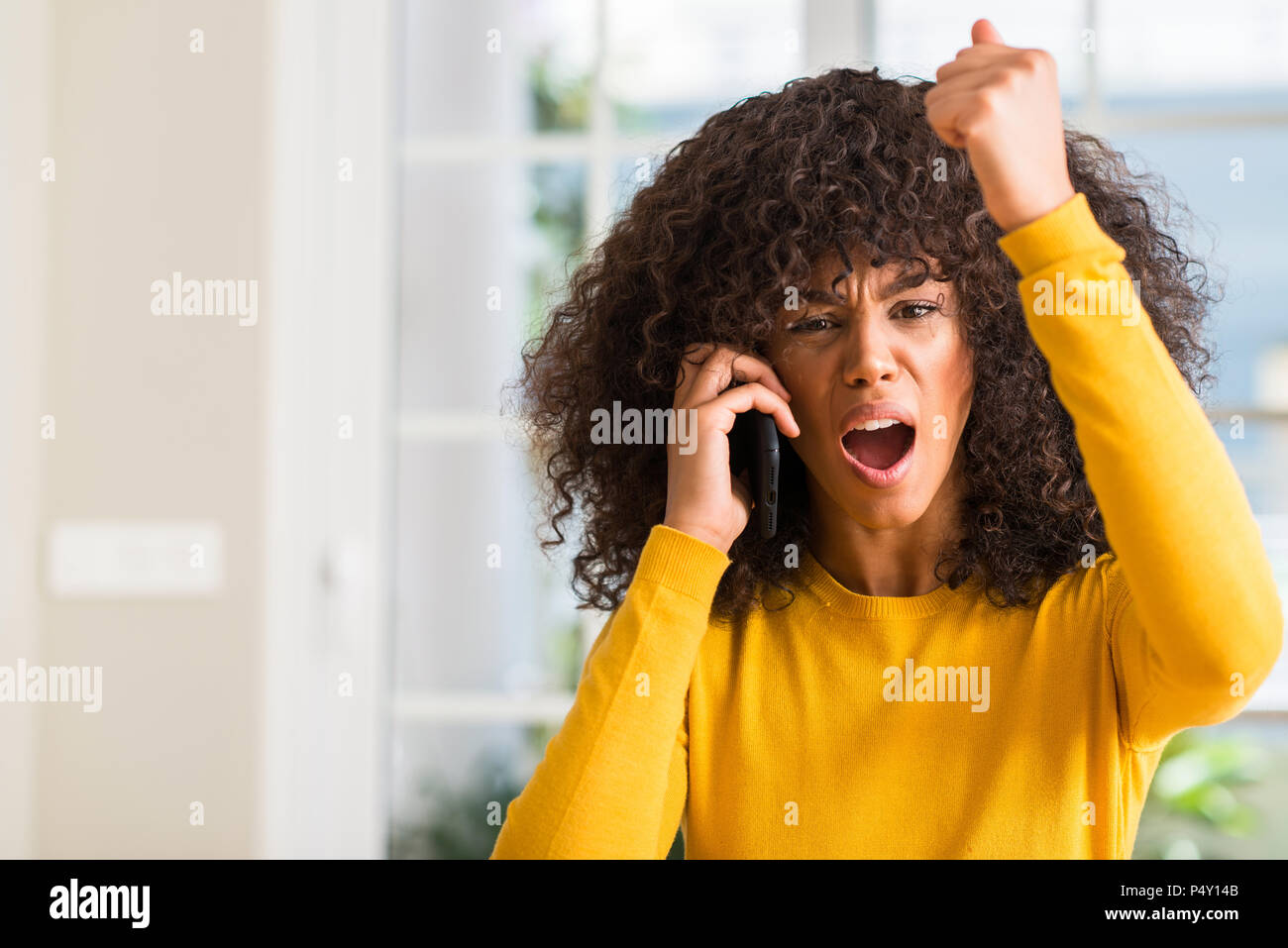 African american woman cell phone mad hi-res stock photography and ...