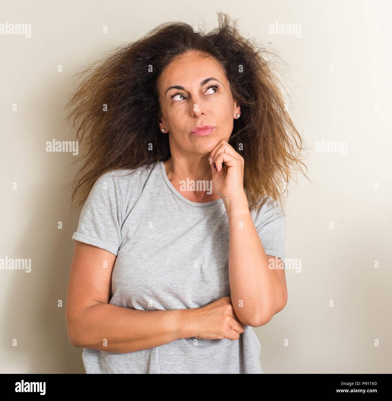 Curled hair brazilian woman serious face thinking about question, very ...