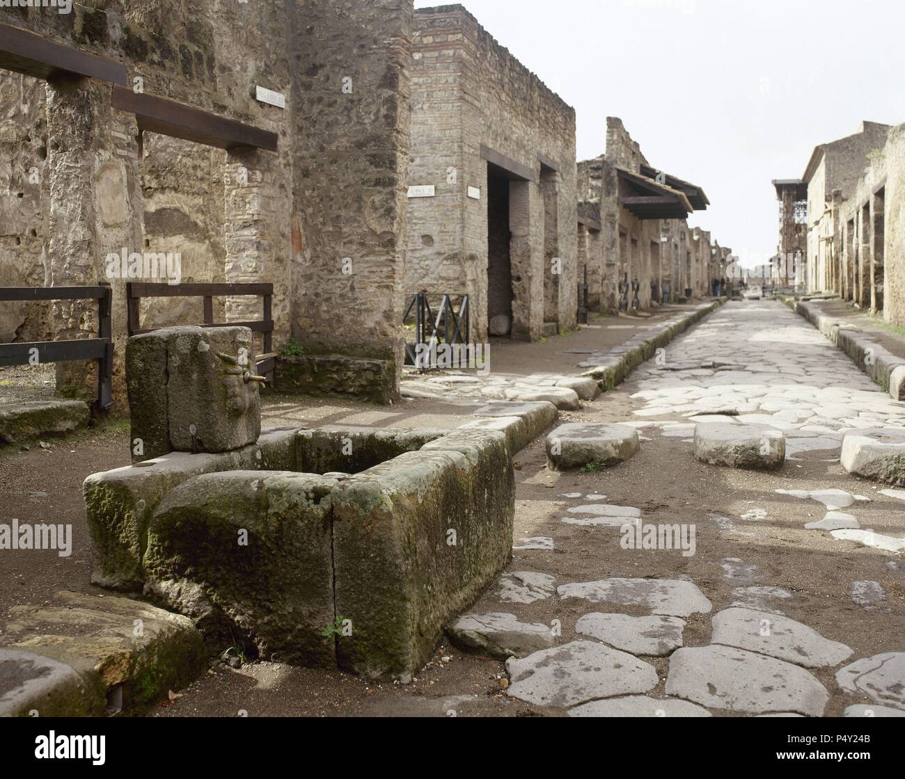 Pompeii. Ancient roman city. Fountain and stepping stone crossing ...