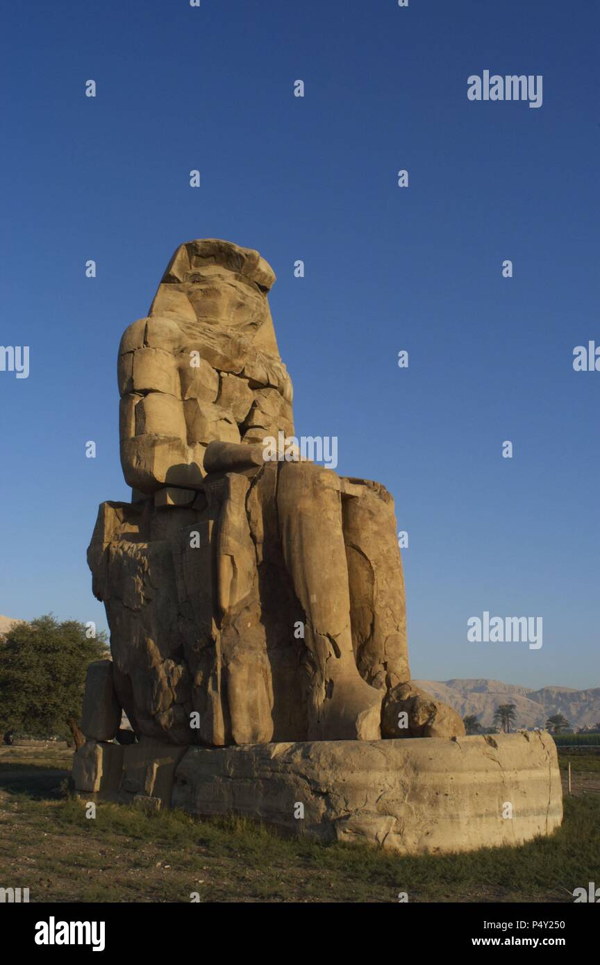 Colossi of Memnon. Stone statues depicting pharaoh Amenhotep III (14th ...