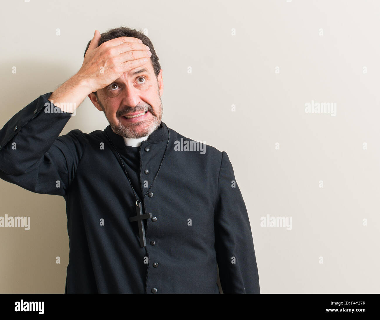 Senior priest religion man stressed with hand on head, shocked with ...