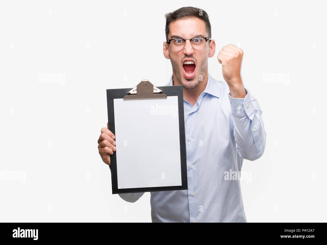 Handsome young business man showing a clipboard annoyed and frustrated ...
