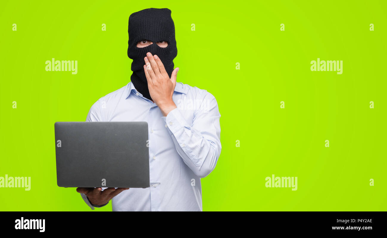 Hacker covering mouth in hi-res stock photography and images - Alamy
