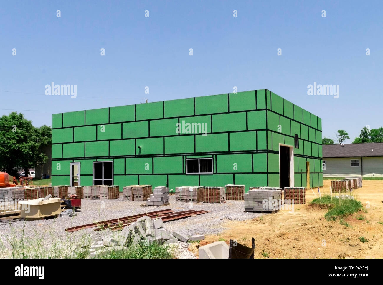 Horizontal shot of a building under construction with green insulation ...